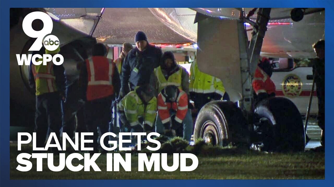 Plane de-boarded at Cincinnati airport after wheel gets stuck in mud ...