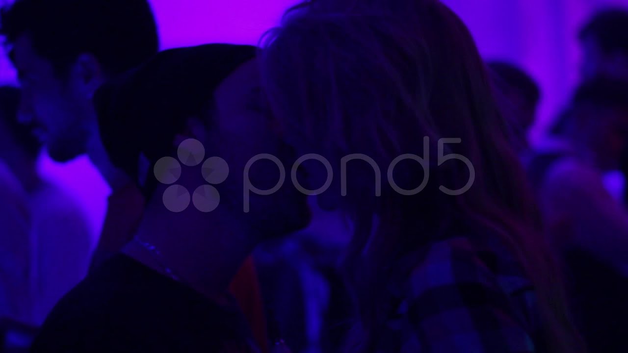 Couple is kissing in night club. Man and woman making out on dance ...