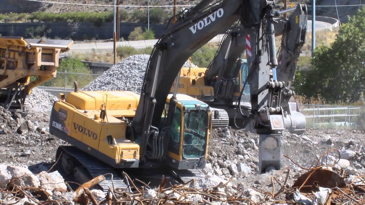Volvo EC360B Excavator using a claw attachment to move metal debris ...