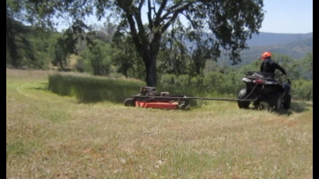 Cutting insane amounts of grass with a pull behind lawnmower - YouTube
