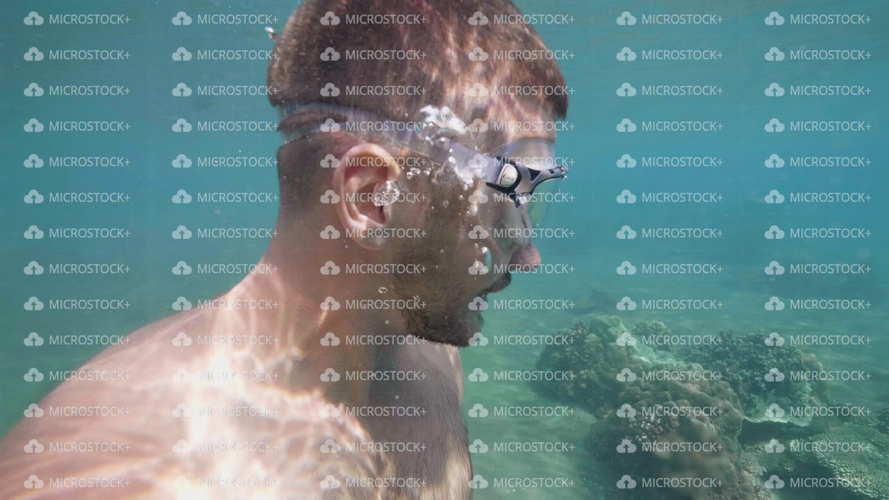 Athletic man is training with dumbbells underwater, hand exercises ...