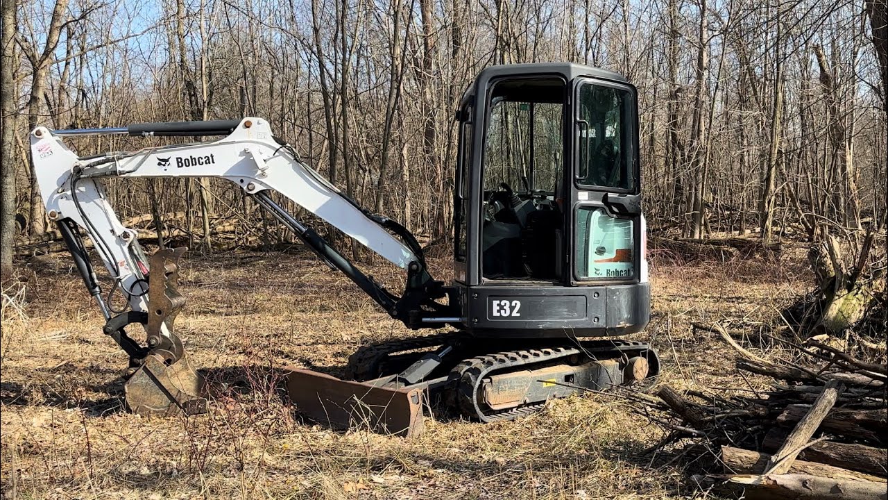 Bobcat e32 Mini Excavator: Digs Fire Pit, Takes Down A Tree - YouTube