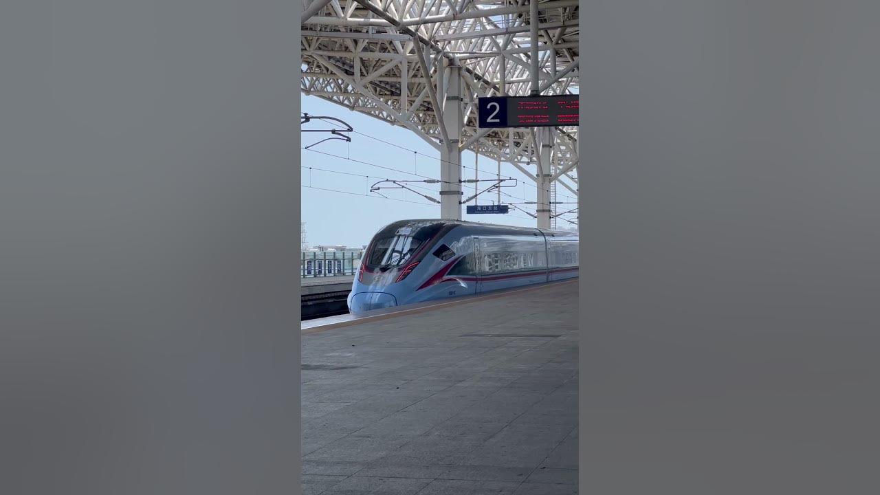 China's high-speed railway: The Fuxing bullet train CR300AF departs from Haikou East Station ...
