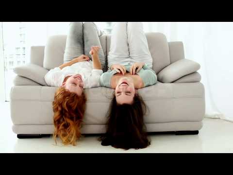 Stock Footage - Two Lovely Women Lying Head First On Couch | VideoHive ...