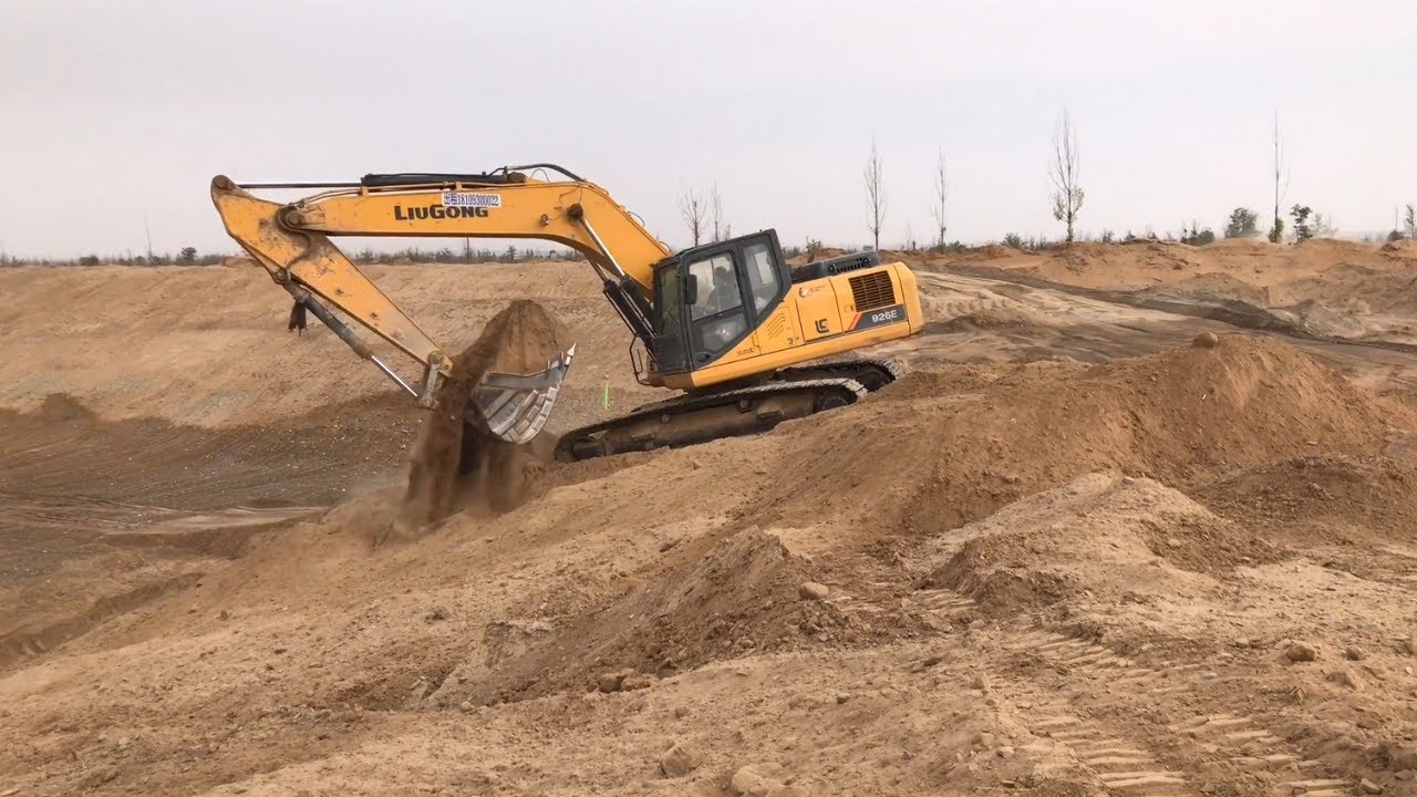 Loaders and excavators leveling the ground at the site. - YouTube