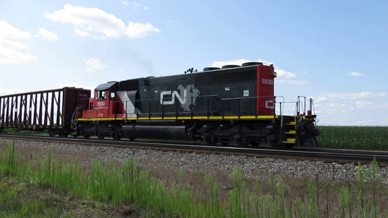 CN SD40-2 GTW 5930 gradually moves East with more freight cars. - YouTube