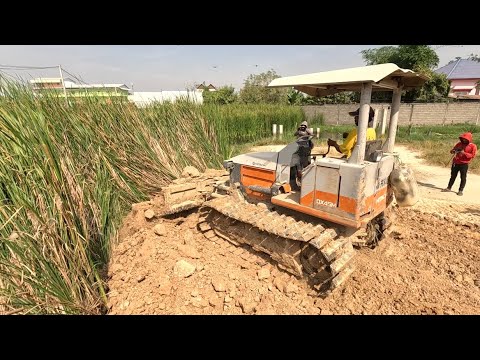 Filling and Pushing the soil onto the big grass in water, Operate by mini dozer HITACHI DX45M ...