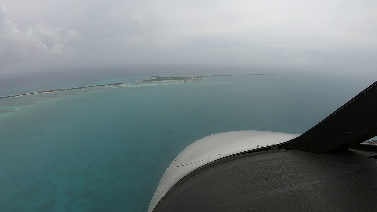 BN2 Islander landing at short runway in Cat Cay, Bahamas with cocpit ...