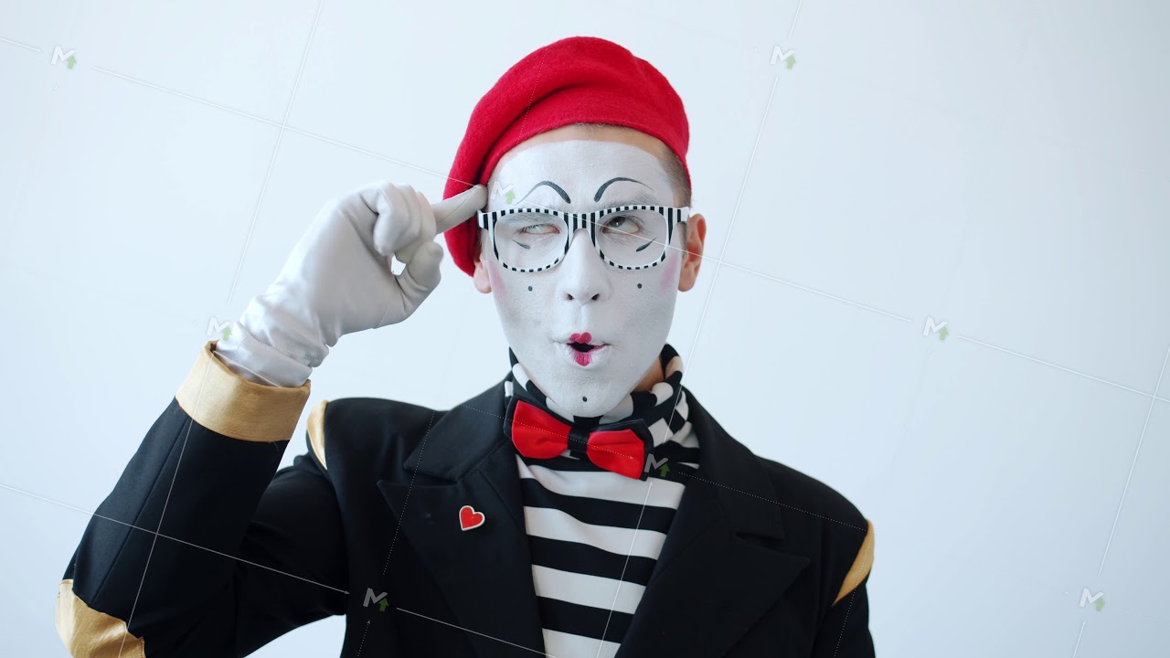 Slow motion of male mime showing crazy hand gesture twisting finger at ...