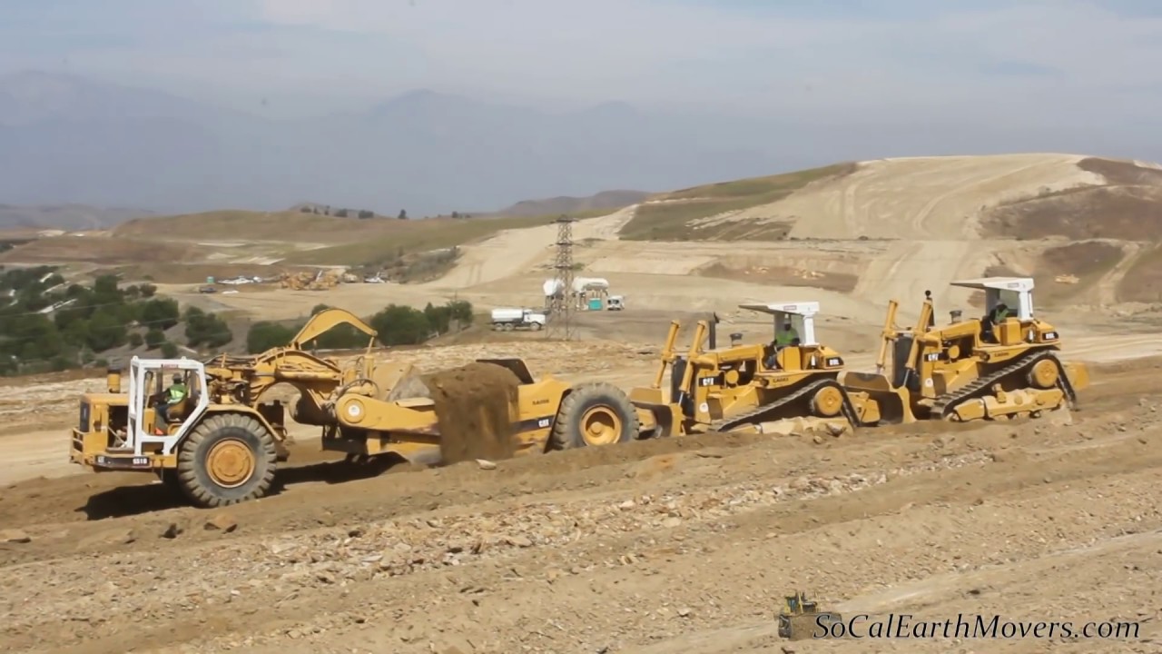 C.A. RASMUSSEN CAT D9L dozers push loading CAT 651B scrapers - YouTube