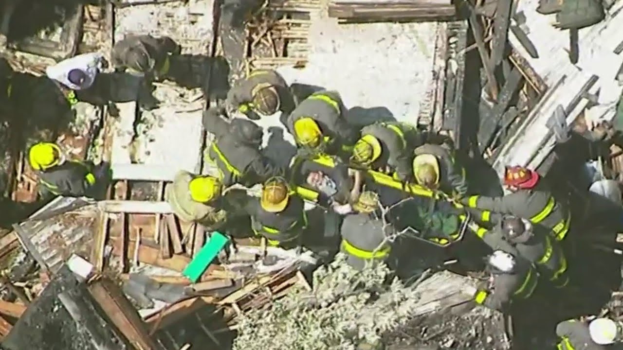 2 firefighters rescued after burning building collapses on them in ...