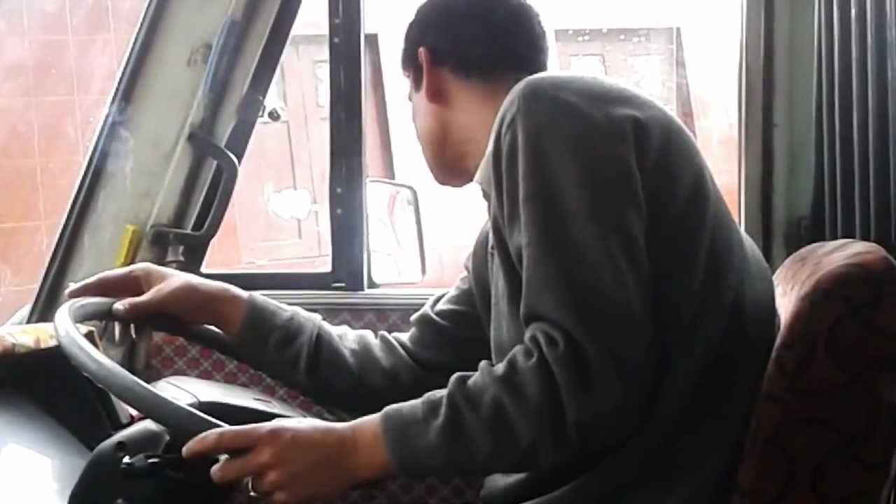 A bus driver smokes inside the bus, passengers doesn't even bother to ...