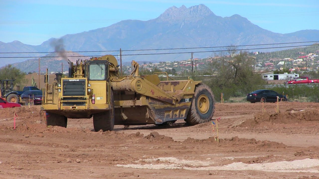 Caterpillar 631E Scrapers And A D10R Push-Dozer Moving Earth Apache ...