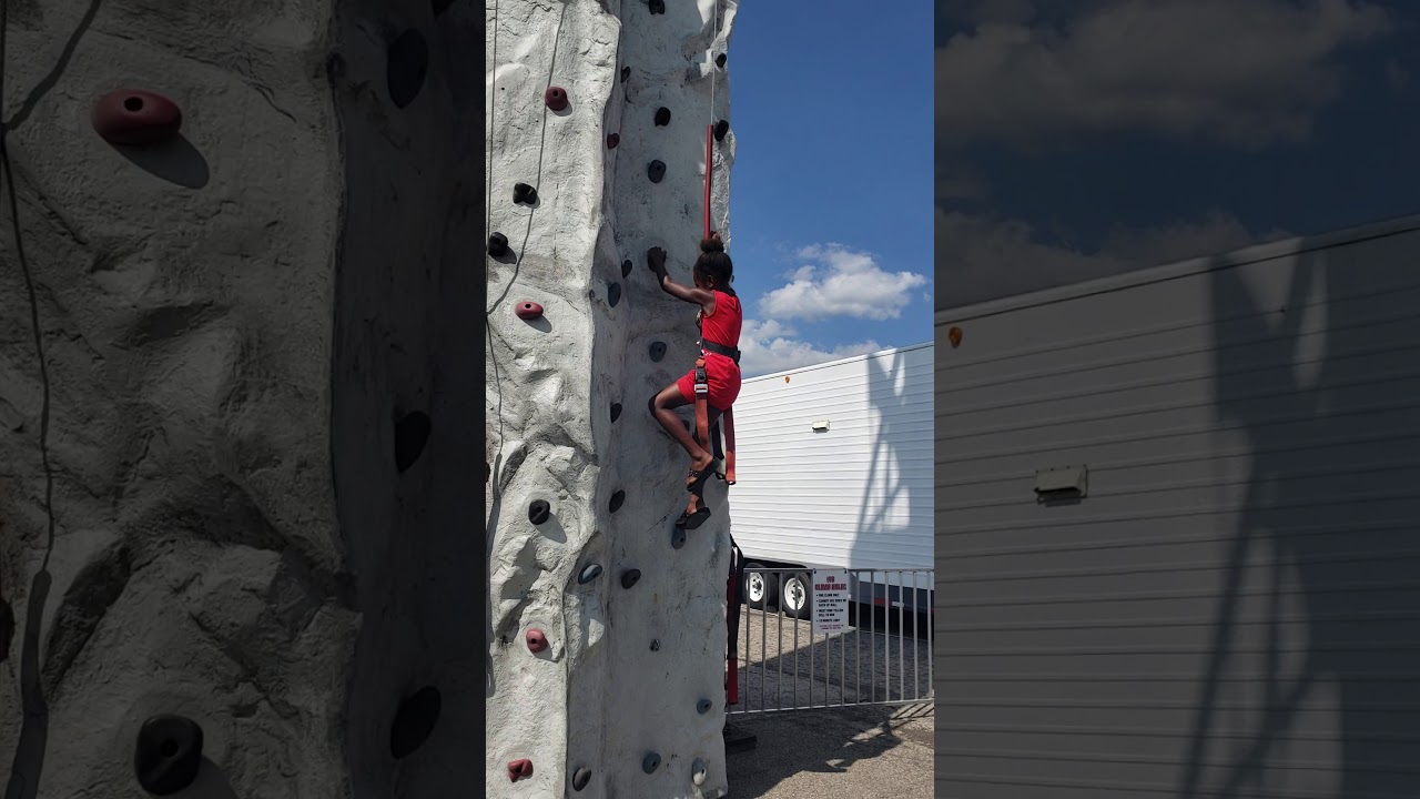 Trin climbs rock wall at fair - YouTube