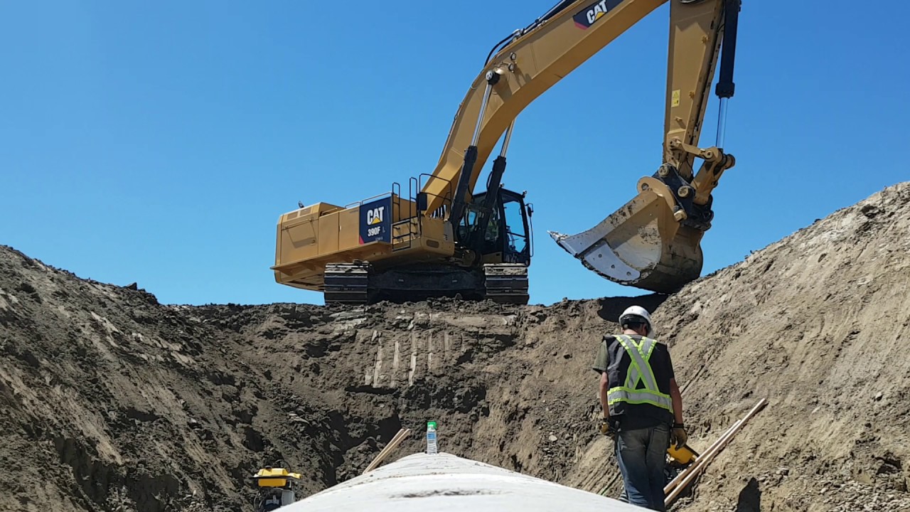 CAT 390 installing mainline storm drain. - YouTube