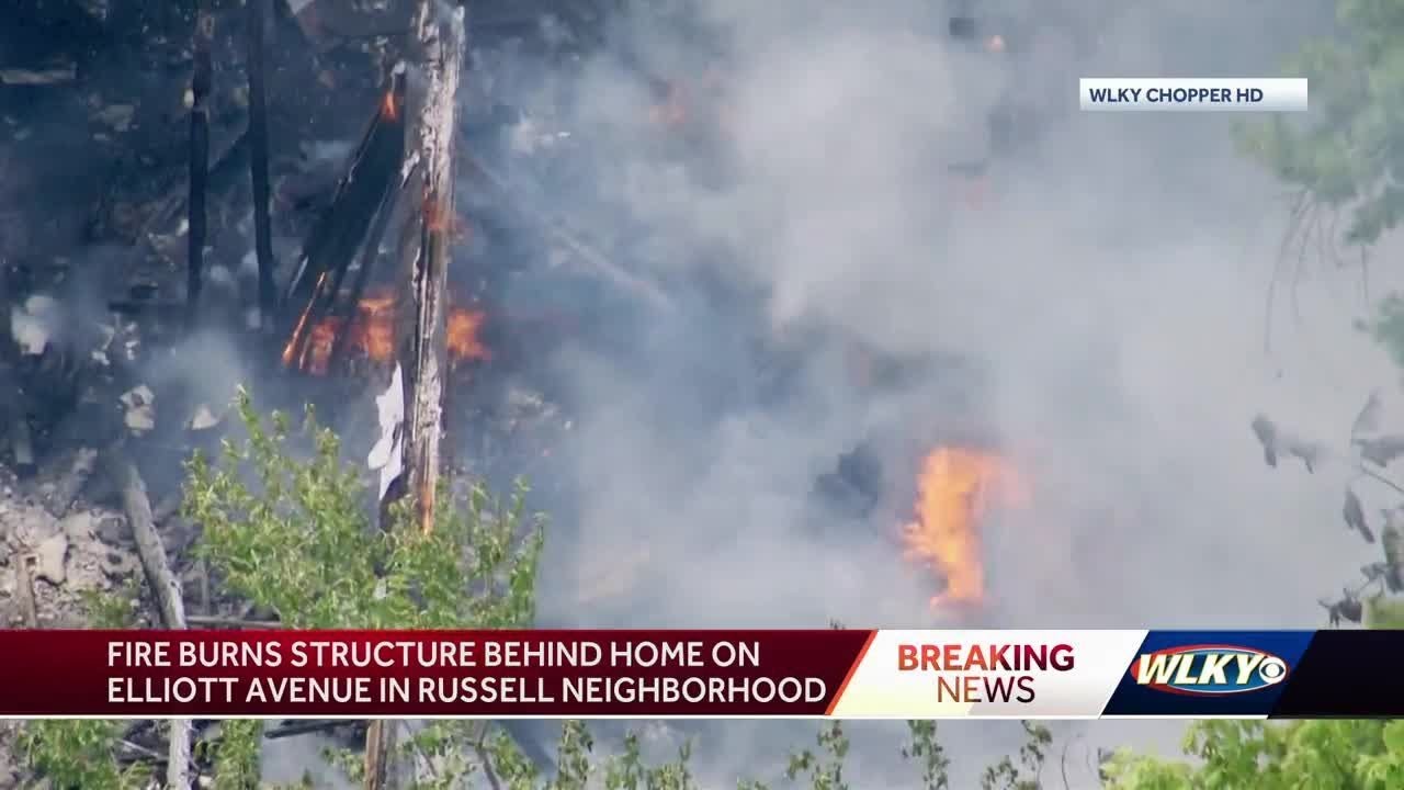 Fire burns structure behind home in Russell neighborhoof - YouTube