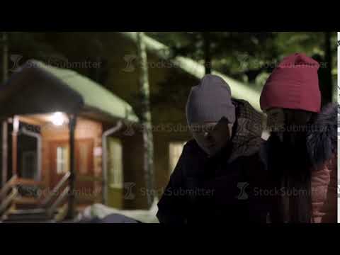 Guy with a girl is sitting on a bench and talking