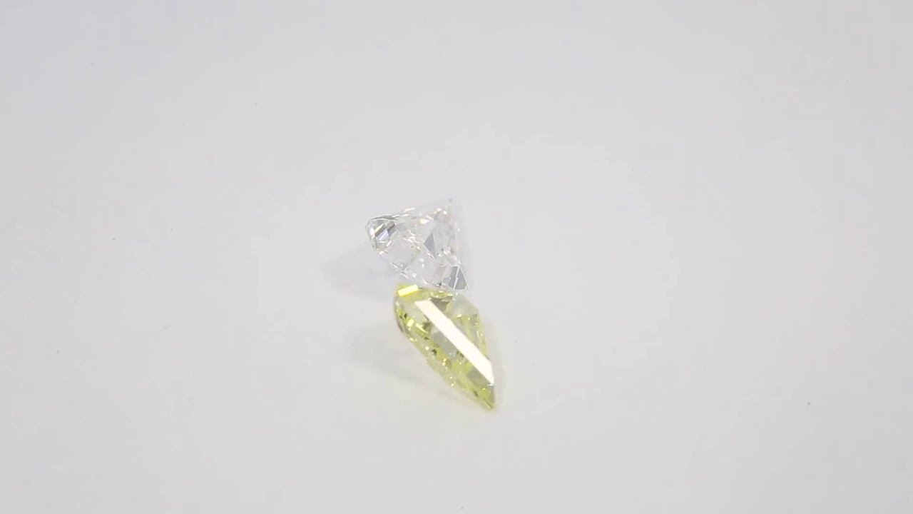 Pair of a Fancy Vivid Yellow Zimi Diamonds and a E VS1 Triangular Shape ...