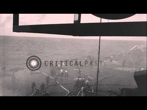 Fire fighting aboard the USS Hancock (CV-19) in the Pacific after explosion of TB...HD Stock Footage