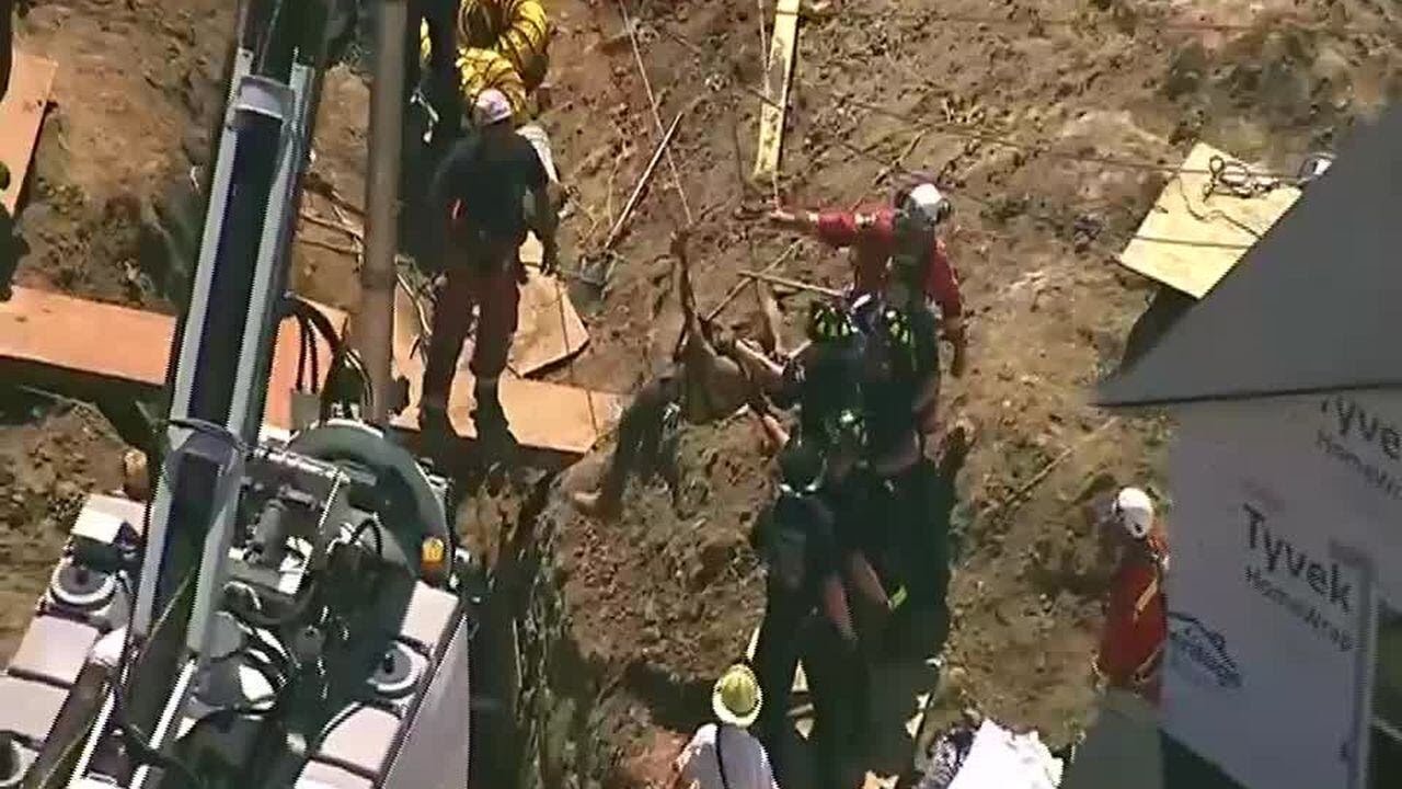 Watch moment crews safely pull man out of trench 20 feet below ground ...