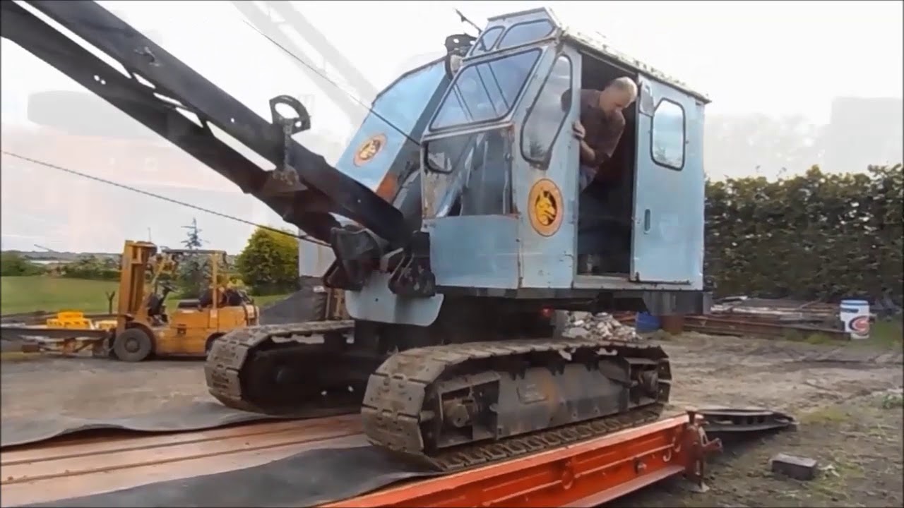 Vintage excavator and trailer. Old school loading. (Contains industrial ...