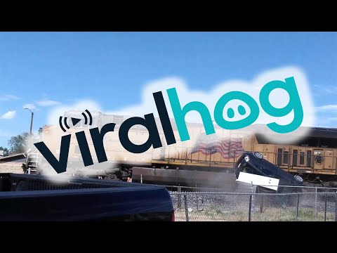 Train Takes out Car Carrier || ViralHog