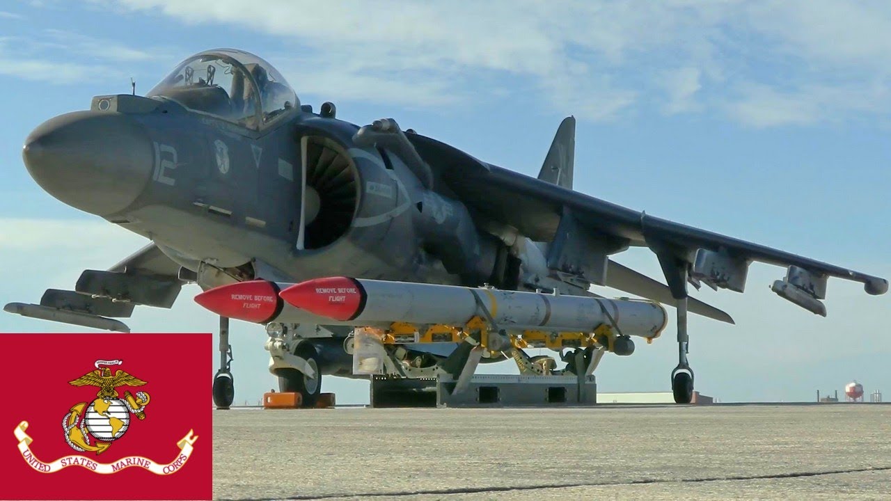 US Marines. Loading powerful air-to-air missiles on an AV-8B Harrier II ...