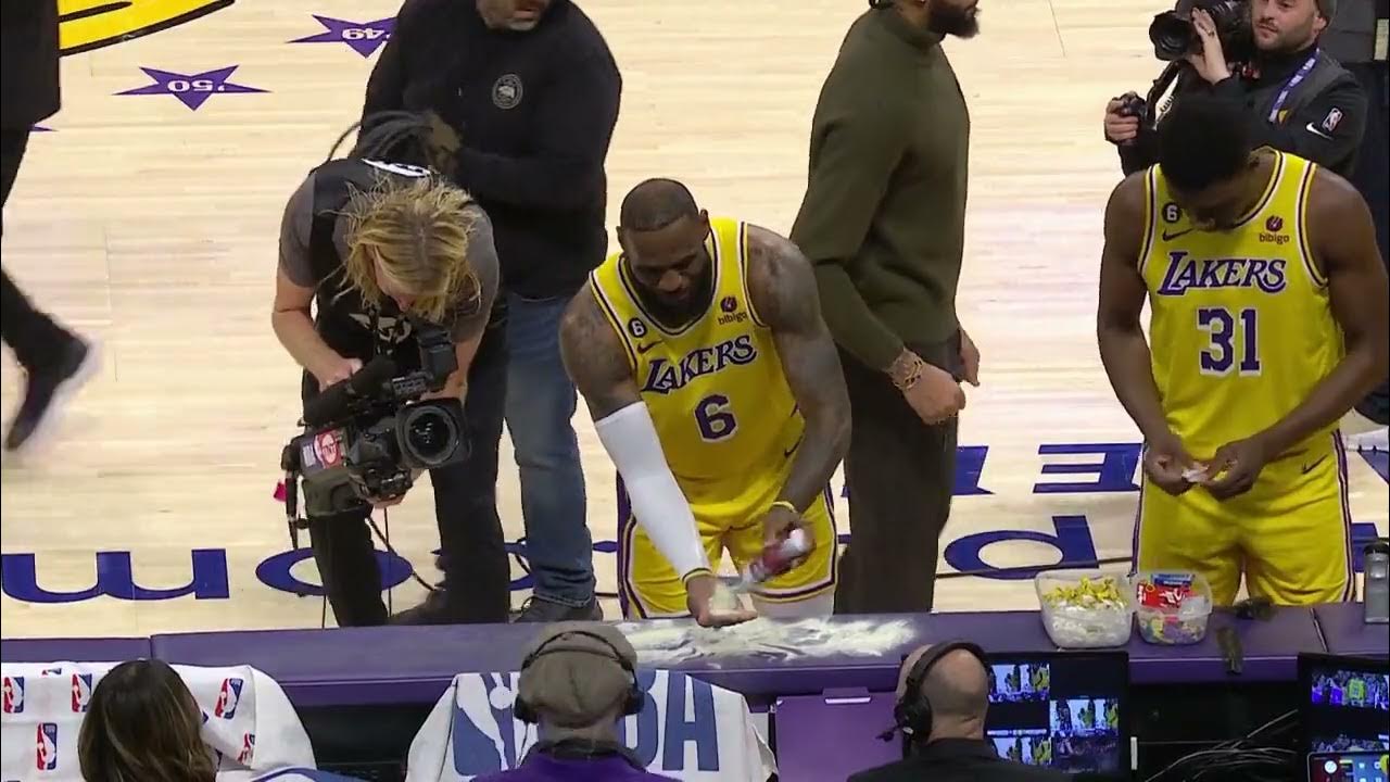 LeBron does his pregame chalk toss and it hilariously falls on AD while he's doing an interview ...