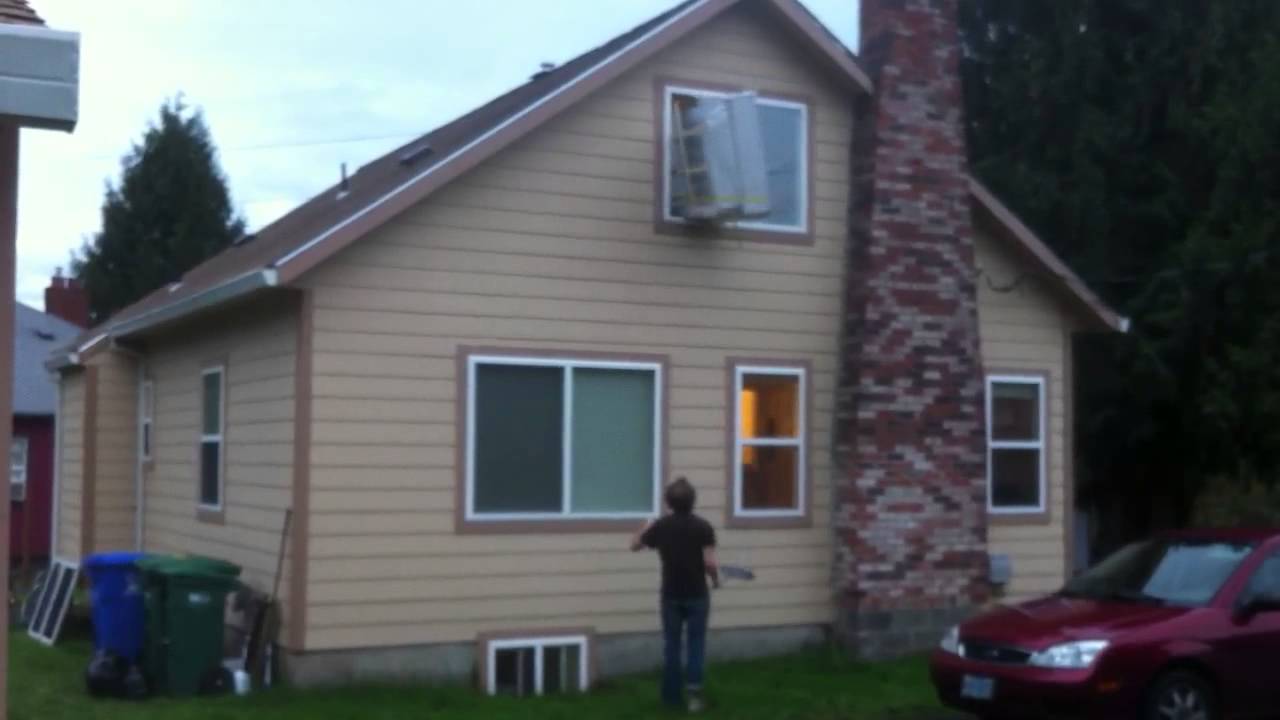 Box spring cut in half and passed through second story wind - YouTube