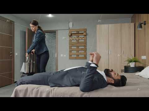 Man and woman with suitcases going inside hotel room lying in bed relaxing