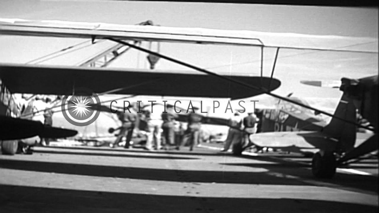Pilots assigned to Piper cub airplanes pose for group picture aboard ...