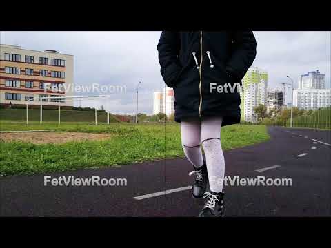 Schoolgirl's legs walking along the road close up