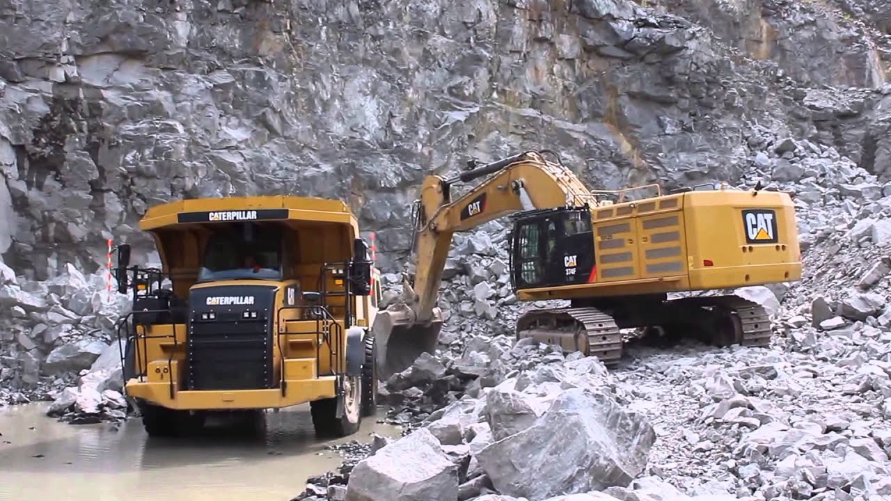 First CAT 374 F LME loads a CAT 772 in a quarry in Germany - YouTube