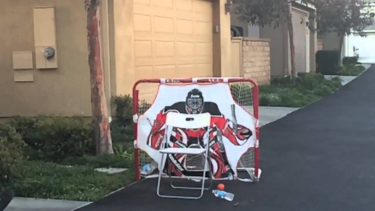 Hitting water bottles in slow-mo with a slap shot! - YouTube