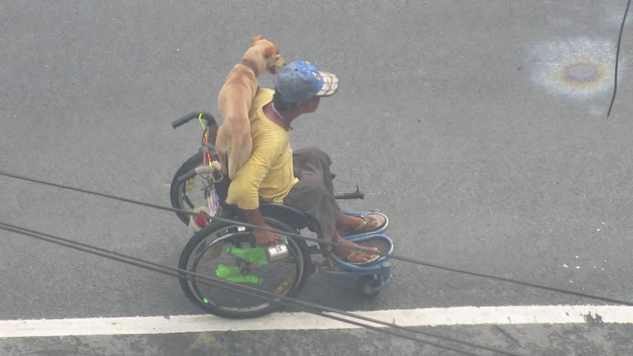 Filipino Beggar And His Buddy Roll Along The Street - YouTube