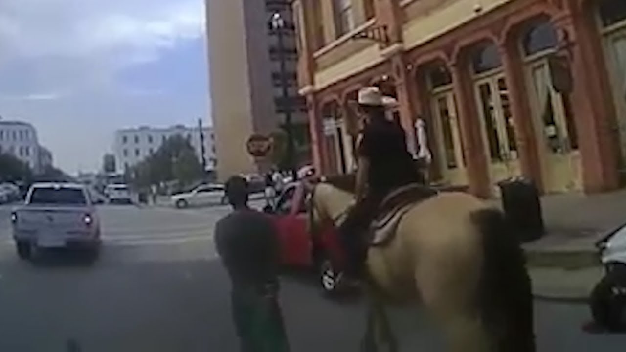 Bodycam footage of mounted officers leading man down the street in ...