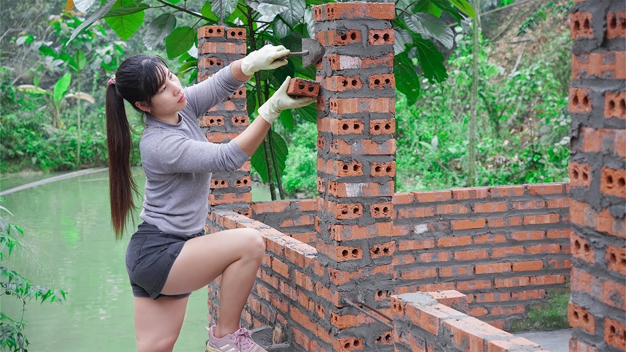 Using bricks and cement to build new pigsty that fits with nature ...