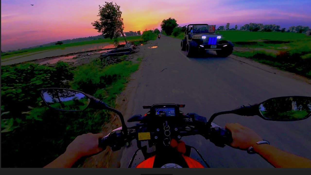 Sunset Moto Ride: Riding Through Lush Green Fields with the Sun in ...