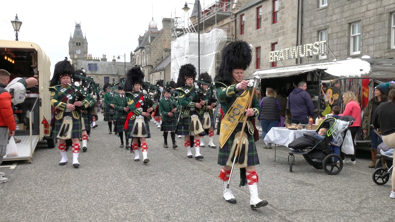 Huntly & District Pipe Band march into Huntly Square as they celebrate ...