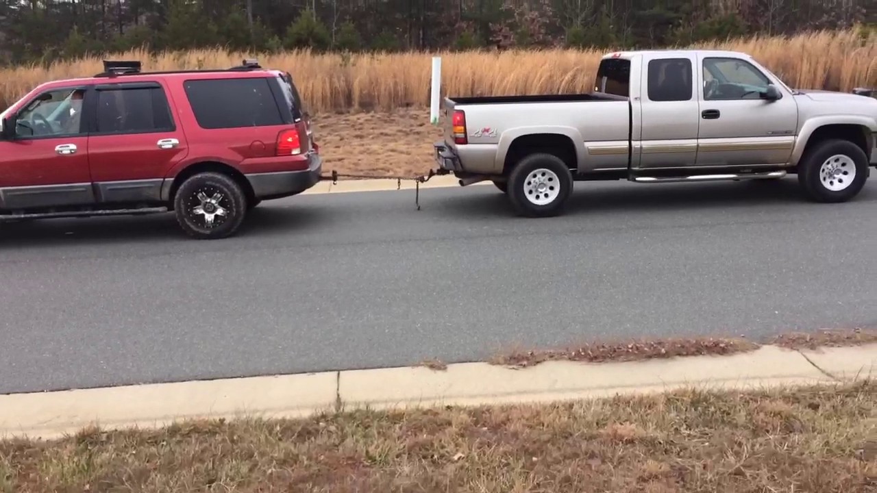 Ford Expedition pulling Chevy truck - YouTube