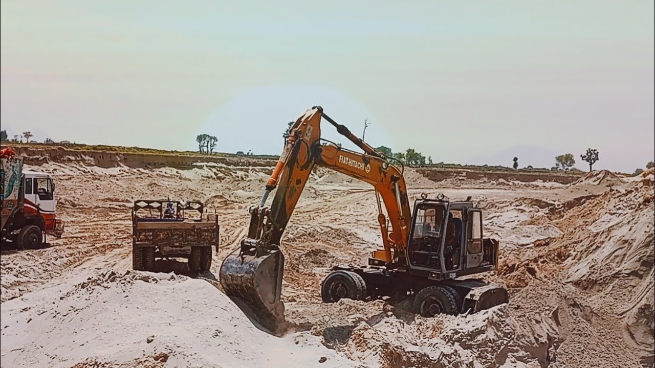 Powerful Excavator At Work: Excavator Loading Trucks in a Massive ...