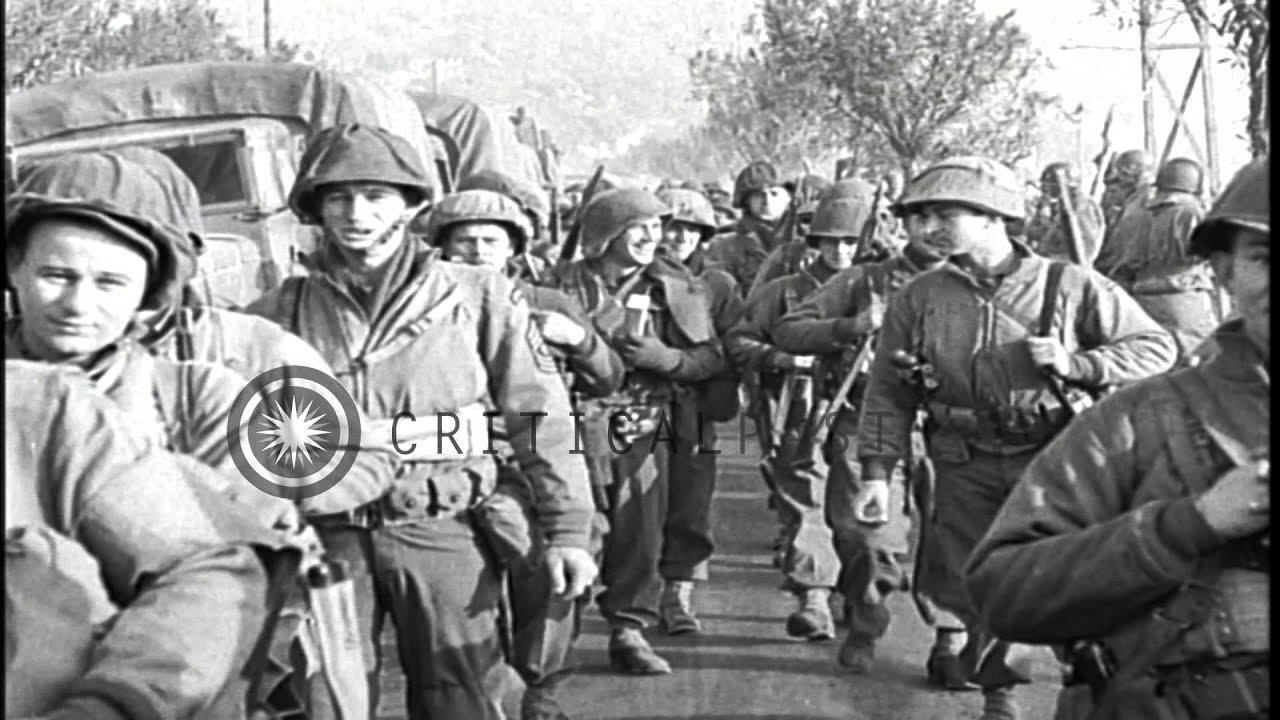 Soldiers in a column of twos march and are checked by officers as they ...