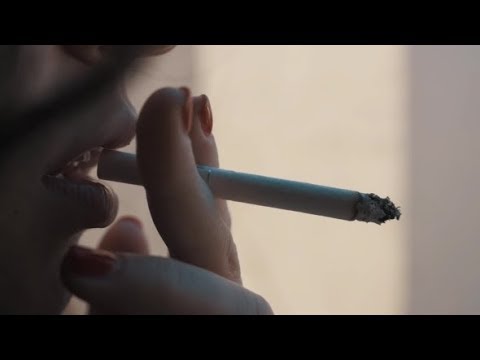 Woman Smoking Cigarette with Fingers with Red Nail Polish | Stock Footage - Videohive