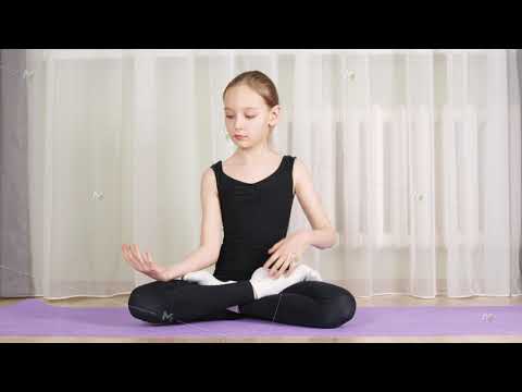 Young girl sitting in lotus pose on home yoga training. Fit young woman training yoga asana on