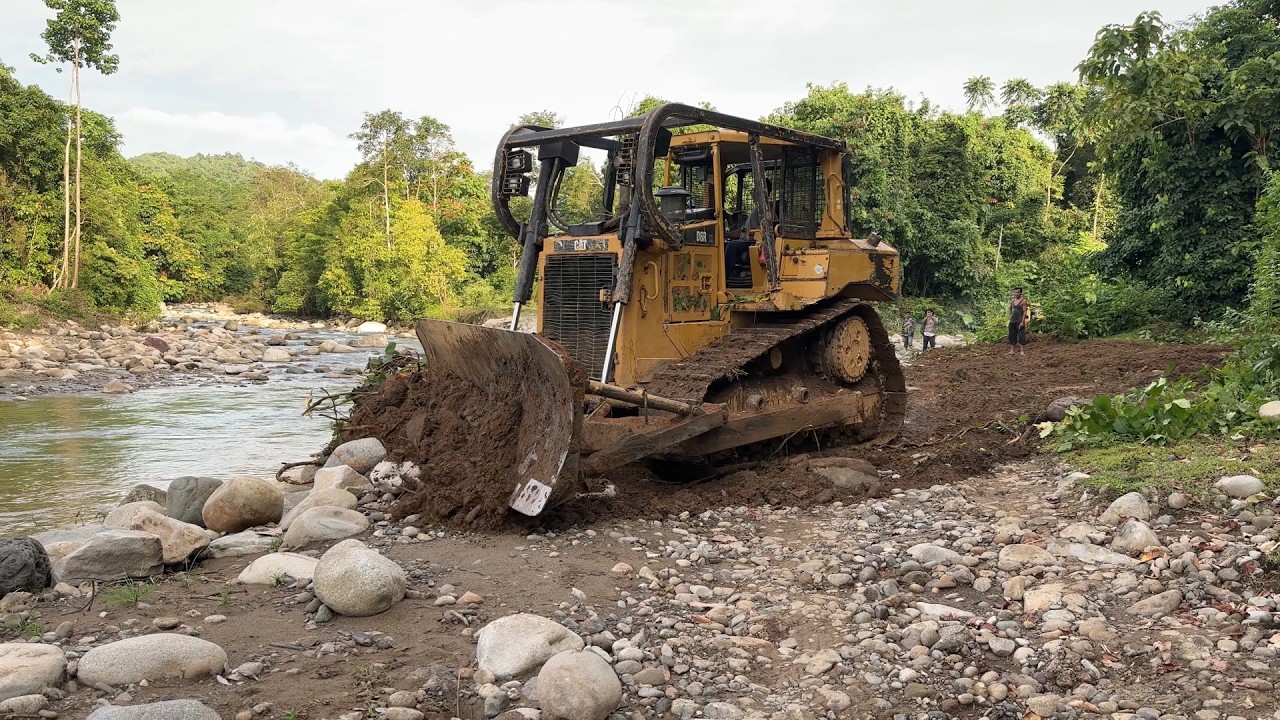 Opening a New Trail with the D6R XL Bulldozer Near the Mountain River ...
