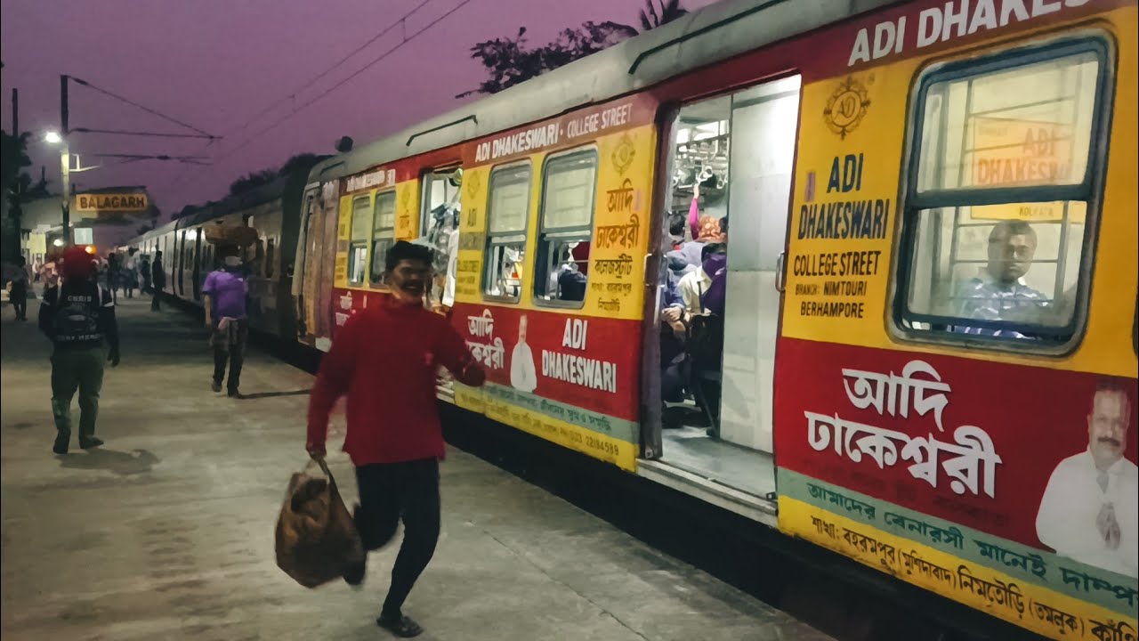 Passenger packed Colorful local train smoothly entering in the evening ...