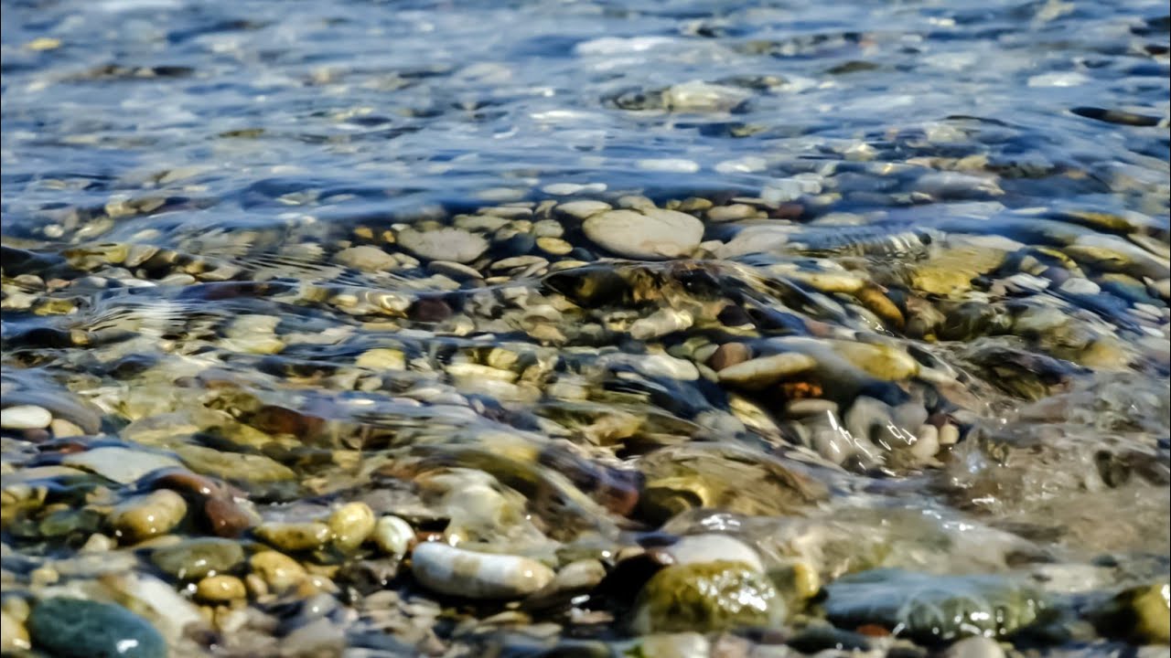 Clear water flowing through river stones with flowing water sound ...