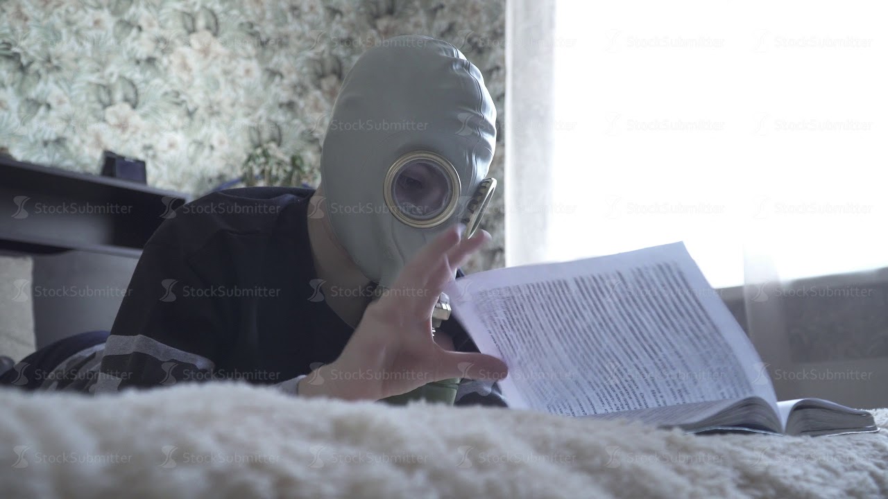 A boy in a gas mask from viruses reads a book - YouTube