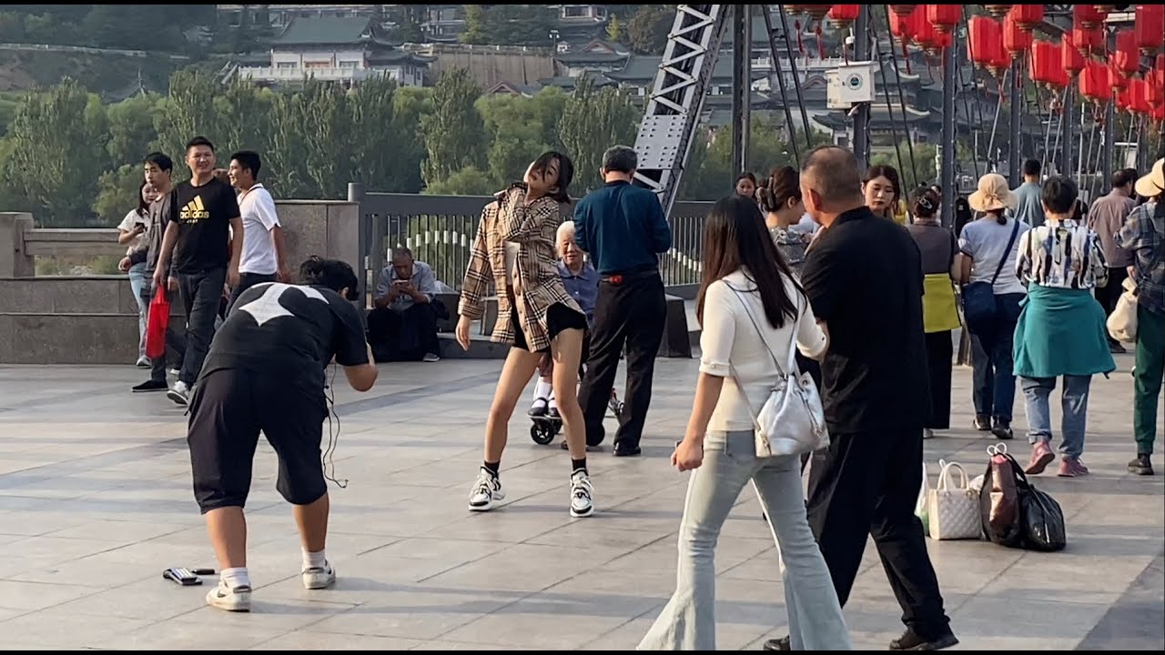 TikTok Craze in the Heart of China! Young Woman Dances in Front of ...