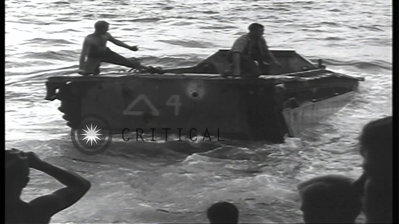 LVT (Landing Vehicle, Tracked) pulled aboard US LST (Landing Ship, Tank ...